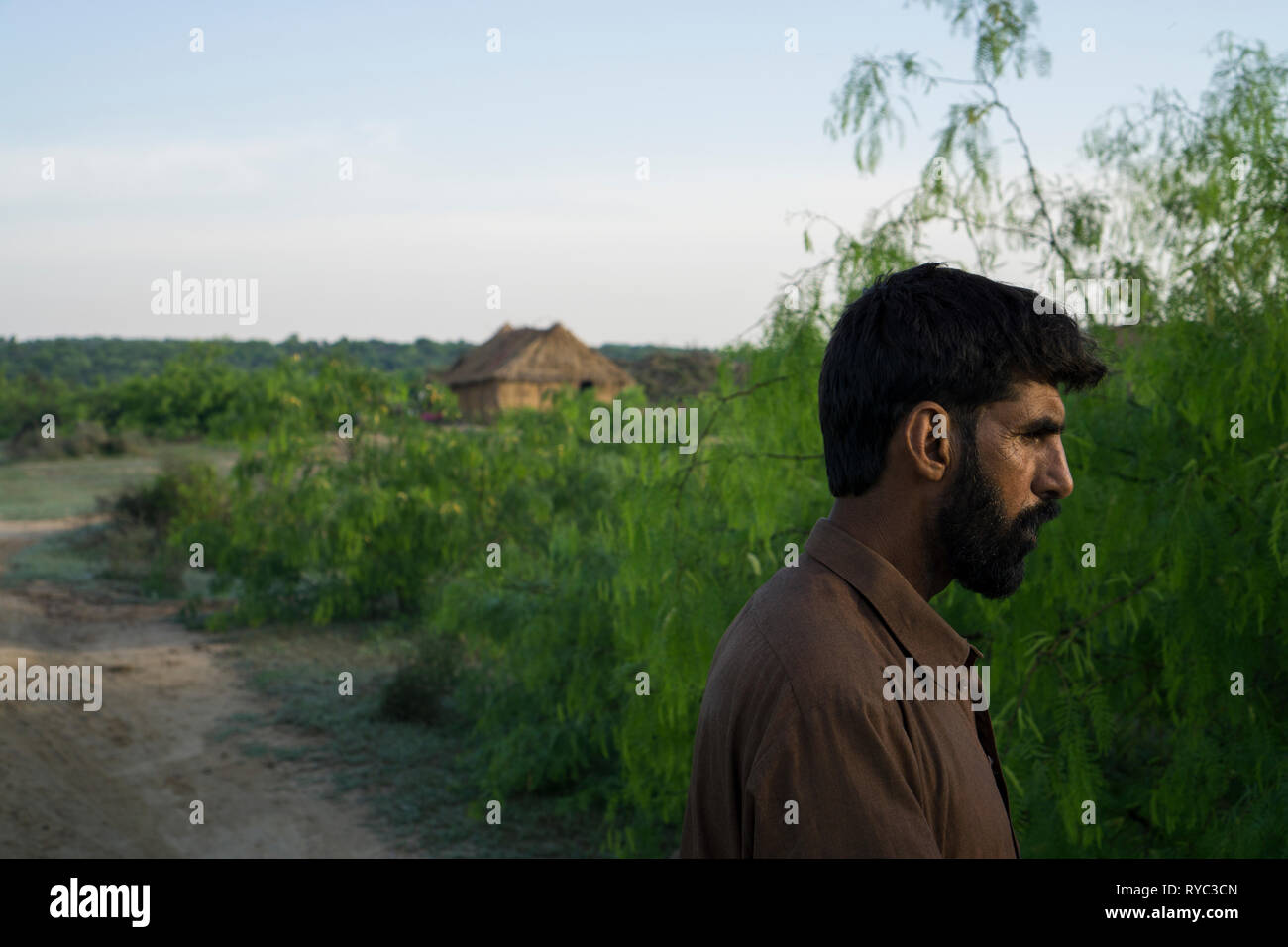 Sad pakistani man looking away outdoors Stock Photo - Alamy