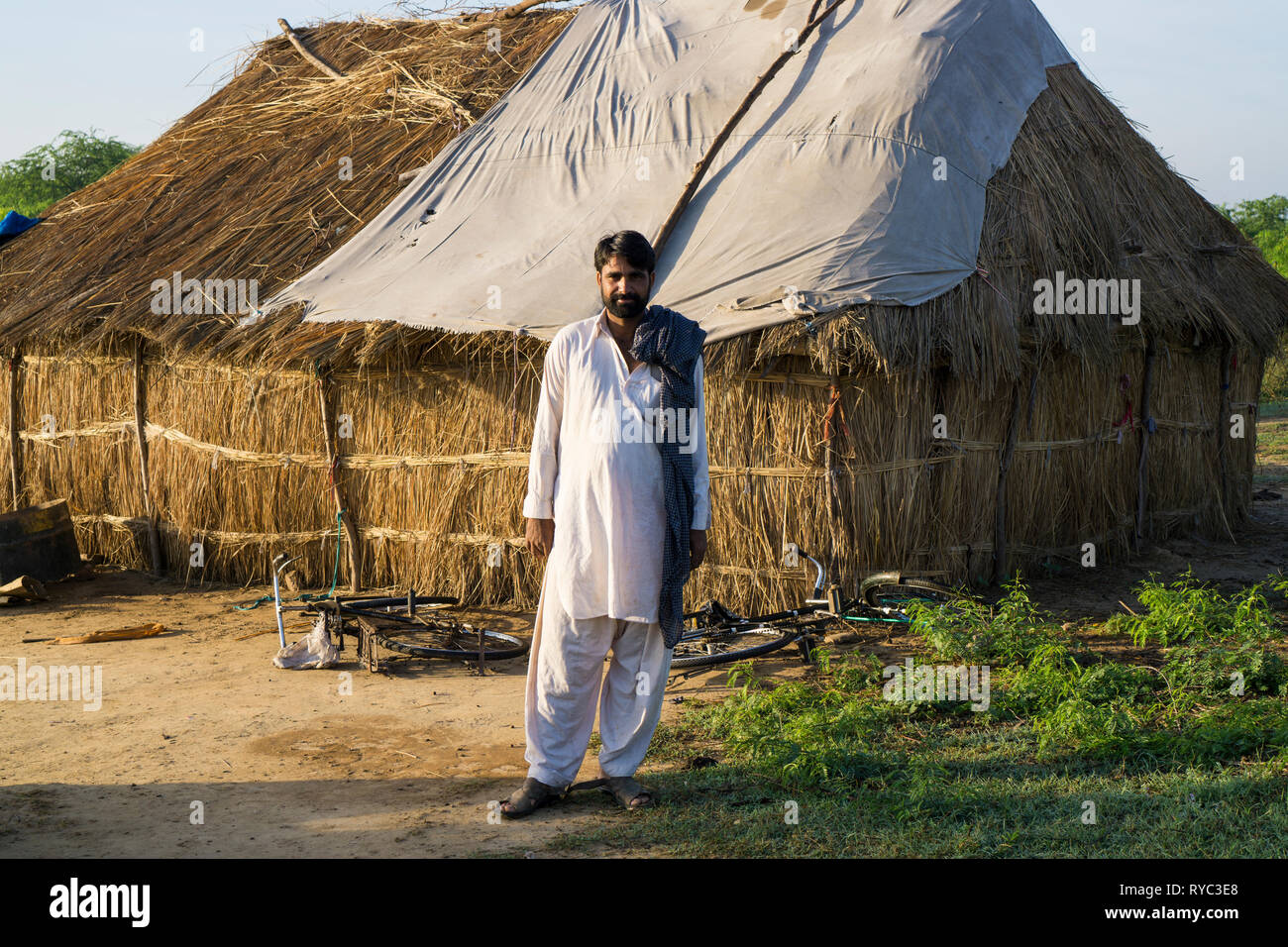 Pakistani man standing outdoors looking at camera Stock Photo - Alamy