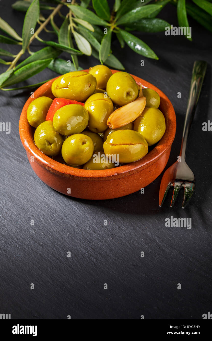 Clay pot with artisan olives (preserved in extra virgin olive oil ...
