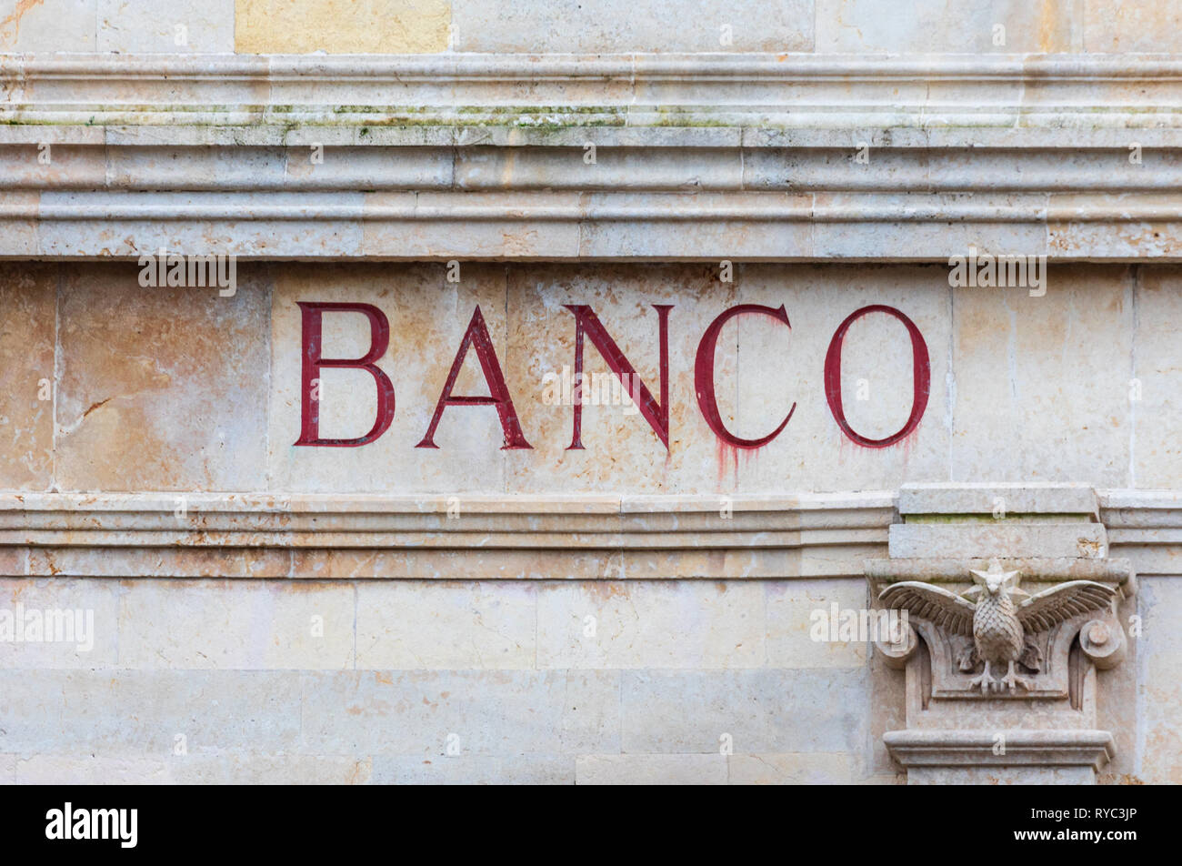 Bank word in Spanish sculpted in stone and red color. Old look Stock ...