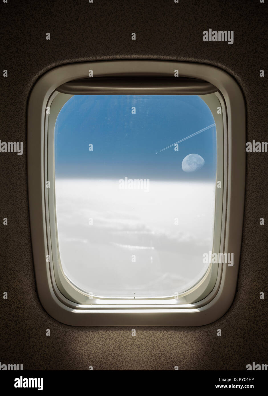 plane flying above the clouds with moon, seen from window airplane ...
