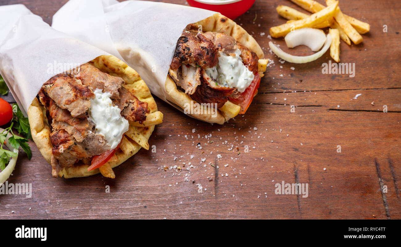 Gyro pita, shawarma, take away, street food. Two pita bread wraps with ...