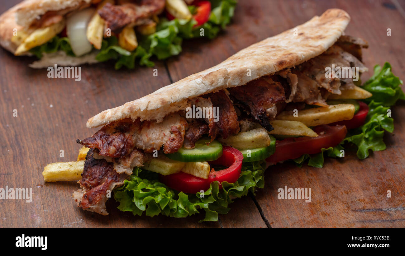 Gyros, shawarma, take away, street food. Sandwich with meat on wooden ...