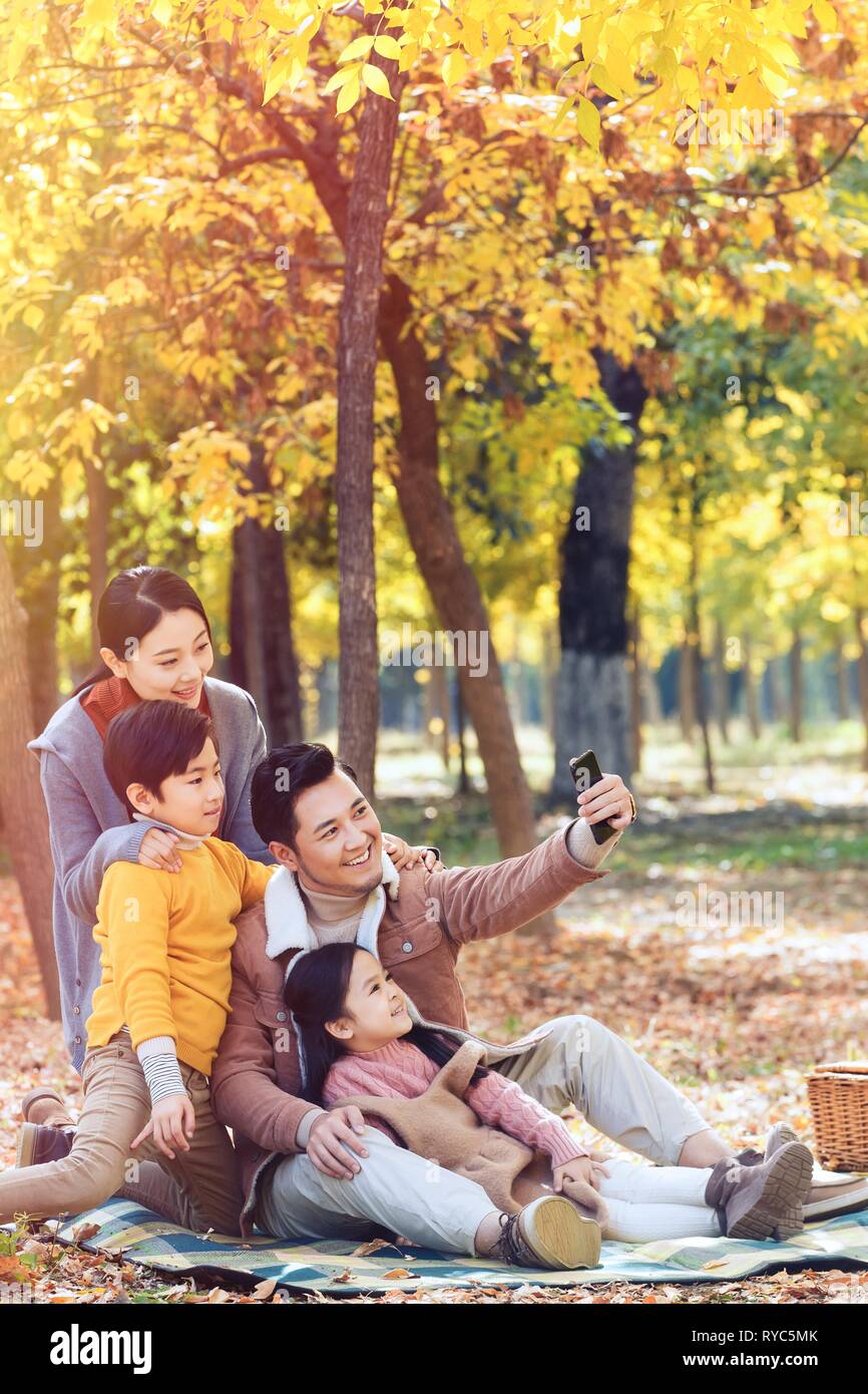 Happy family in the outdoor taking pictures Stock Photo - Alamy