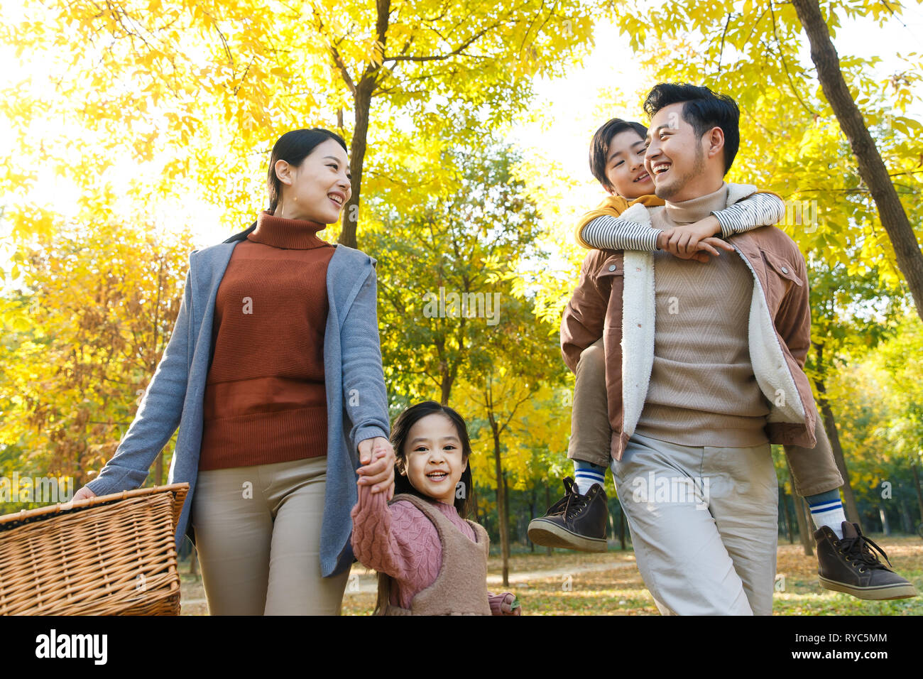 Happy families play outdoors Stock Photo - Alamy