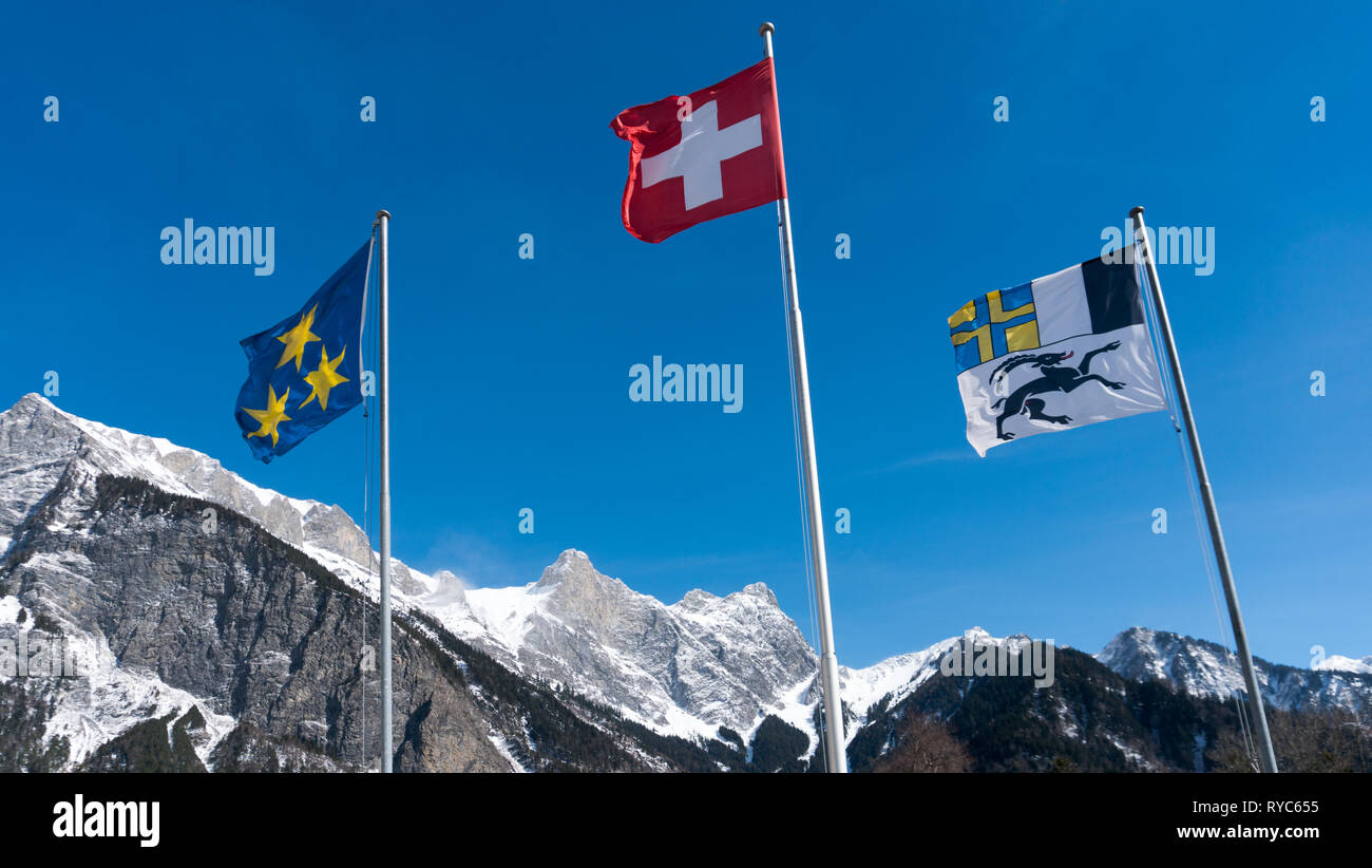 flags of Switzerland and the canton Grisons and the city Maienfeld in a ...