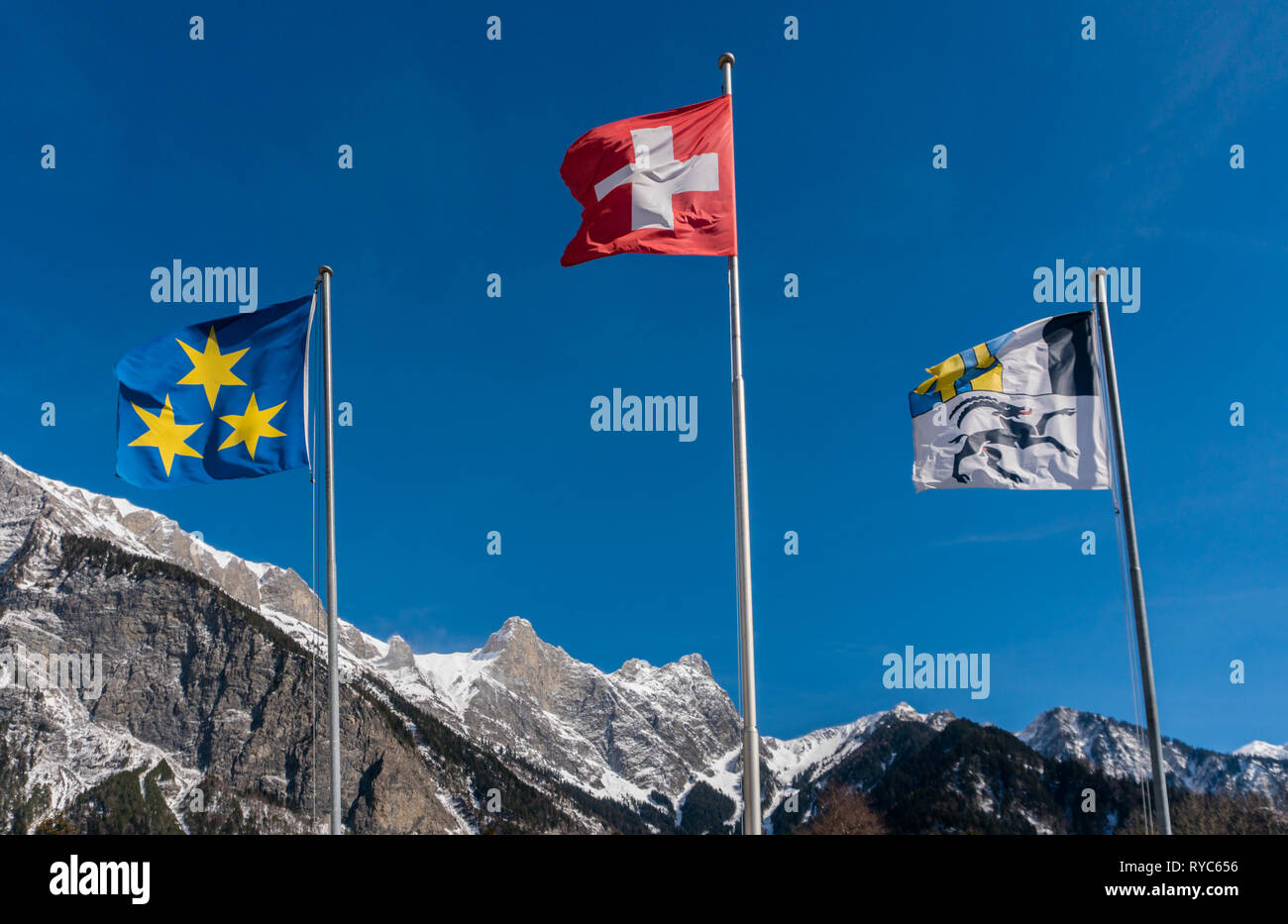 flags of Switzerland and the canton Grisons and the city Maienfeld in a ...