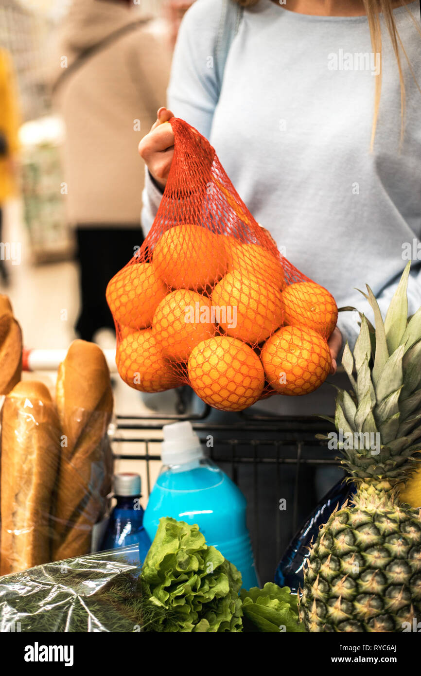 Young woman choose fresh oranges at supermarket Stock Photo - Alamy