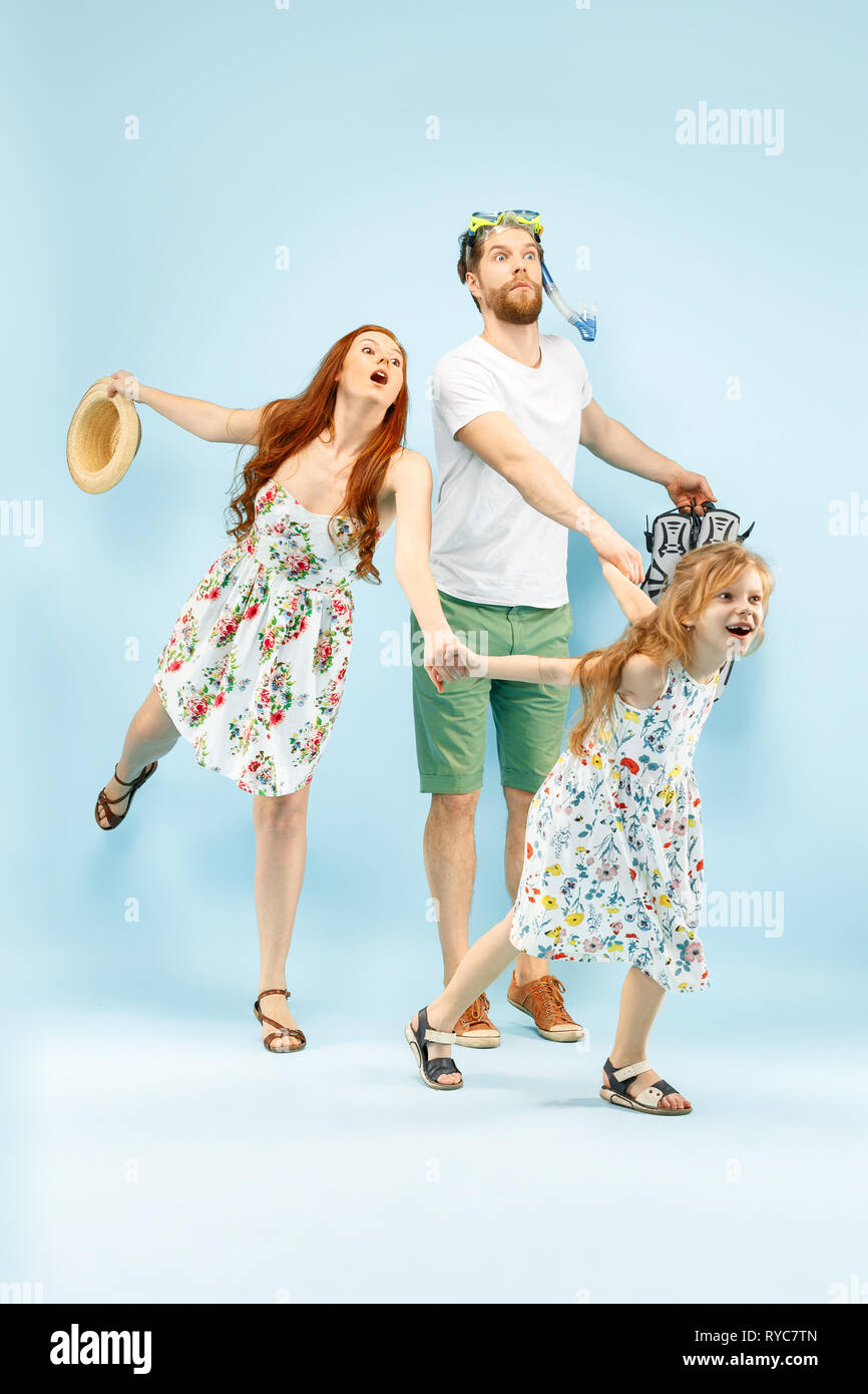 Happy surprised parent with daughter at studio isolated on blue ...