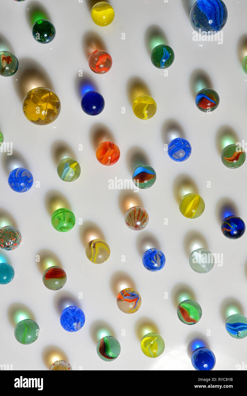 Glass marble balls and shadows on table Stock Photo - Alamy