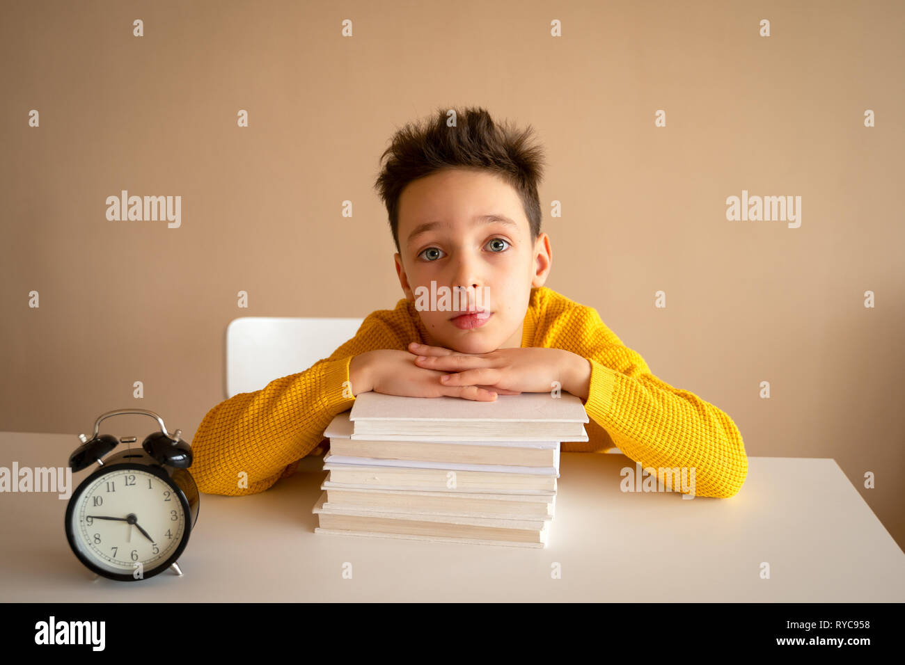 Thinking child bored, frustrated and fed up doing his homework Stock ...