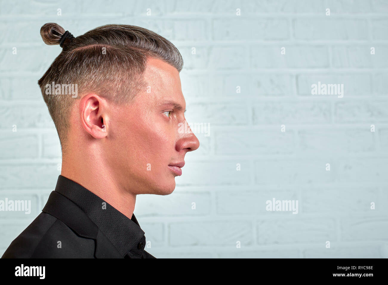 Close up side portrait of young, happy manager standing over grey ...