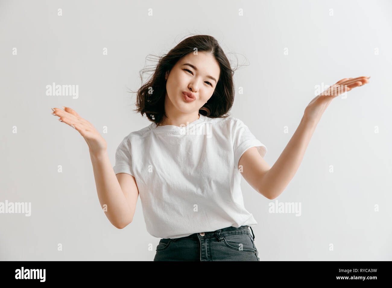 Happy Asian Woman Standing And Presenting Something Isolated On Gray