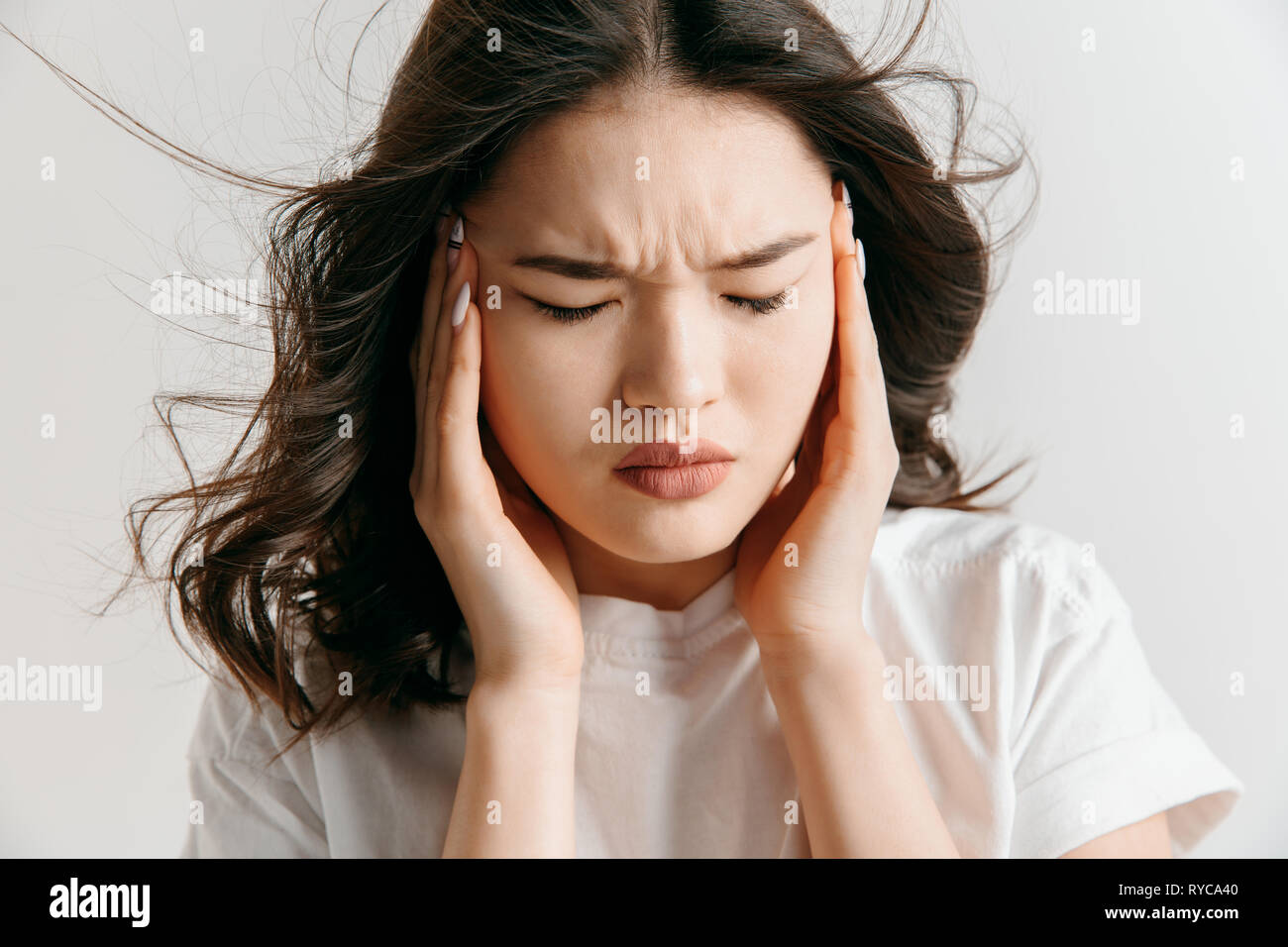 Woman having headache. Isolated on gray background. Businesswoman ...
