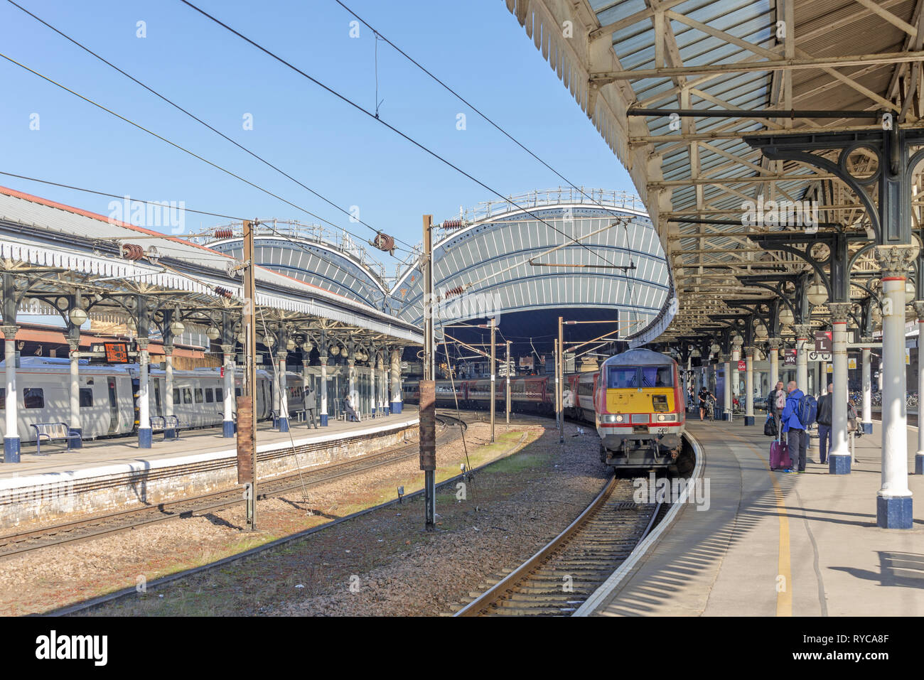 A platform at York Railway Station on a sunny afternoon. Shadows fall ...