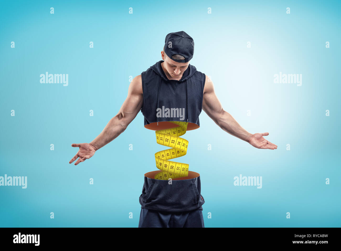 Strong muscular young man cut in half with yellow measuring tape inside ...