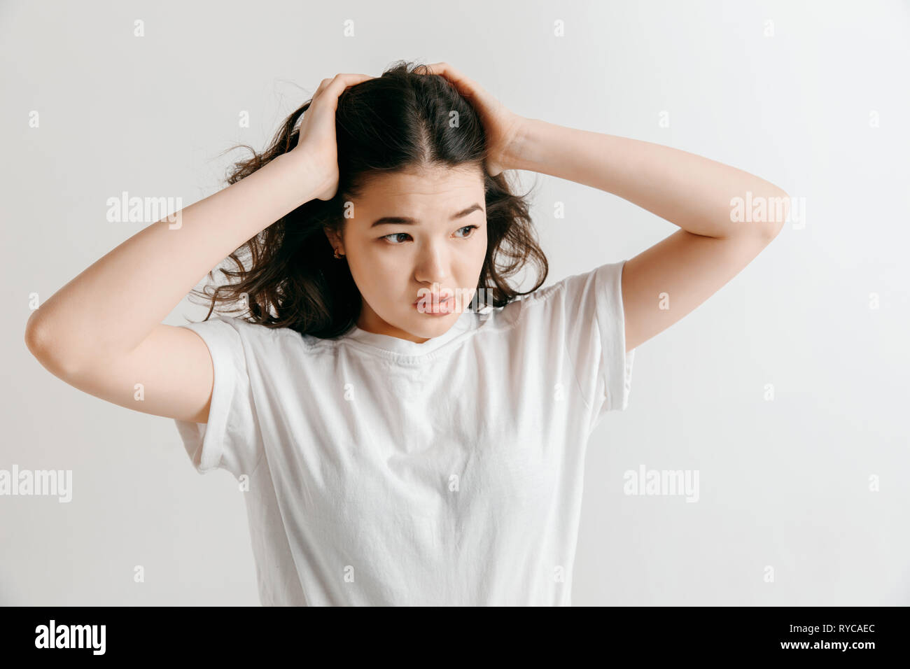 Why is that. Beautiful female half-length portrait isolated on gray ...