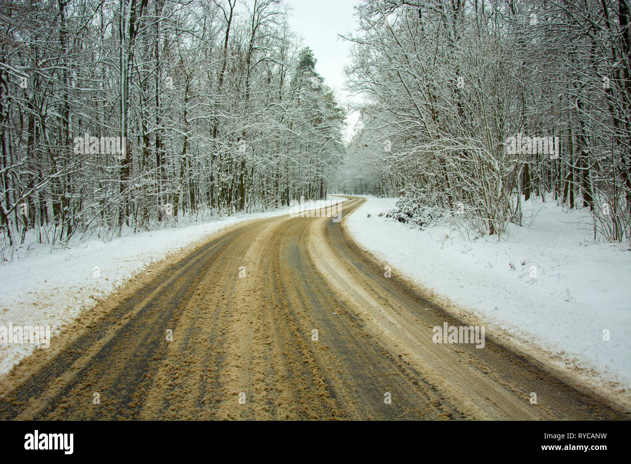 Winding road through snow covered winter landscape hi-res stock ...