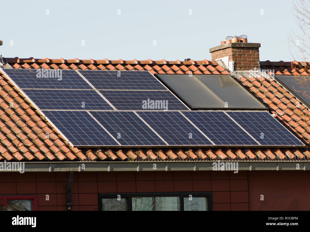 Solar panels on a red roof for electric power generation Stock Photo ...