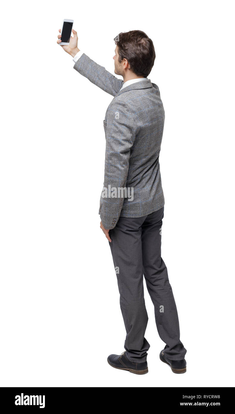 Back view of a business man in a suit making a selfie. rear view people ...