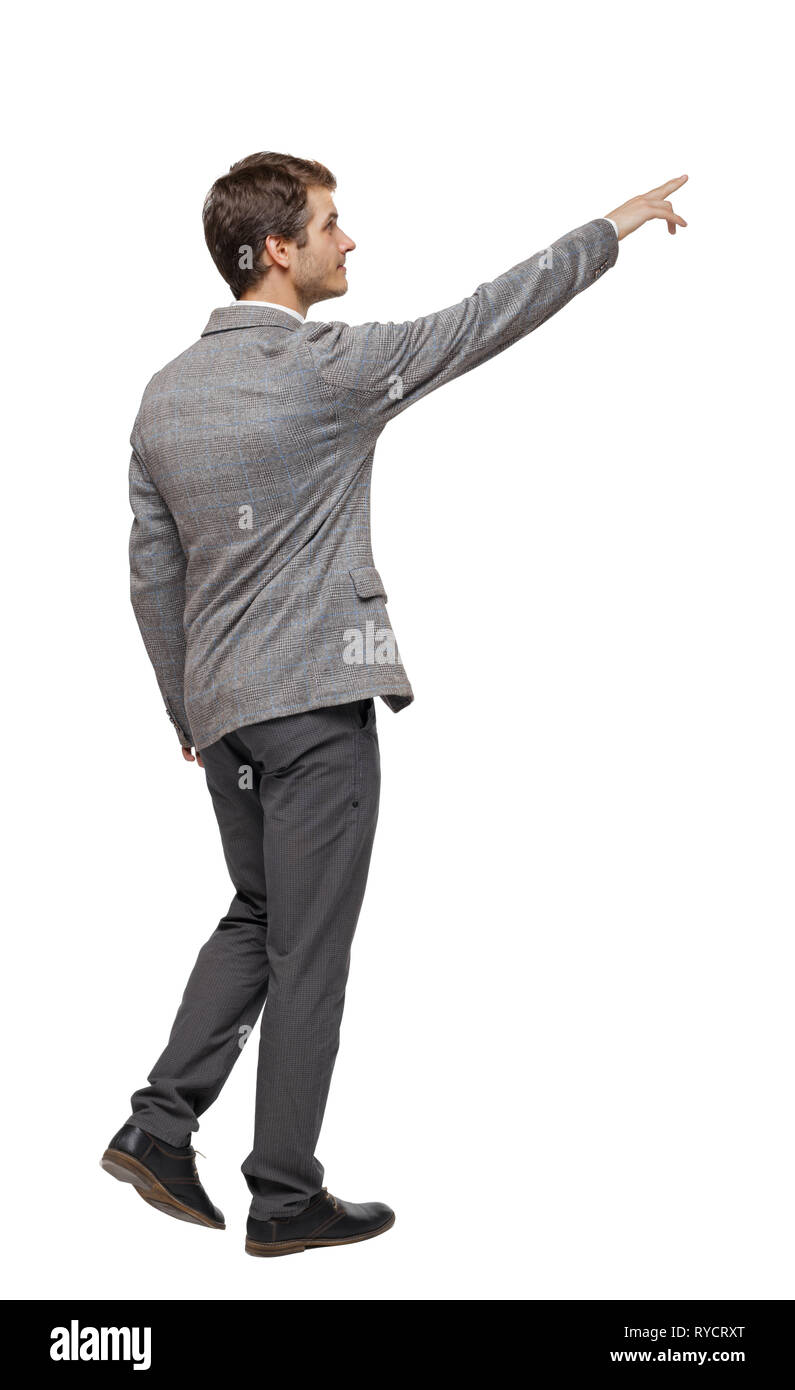 Back view of walking pointing business man. gesticulating young guy in ...
