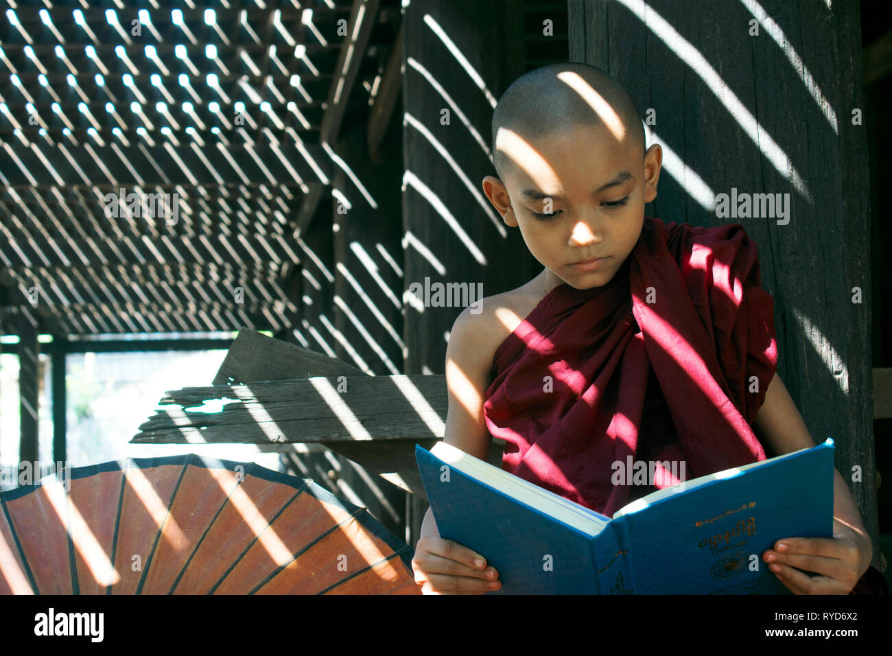 Yong Buddhist Monk is reading under the rays of sun at the Monastery ...