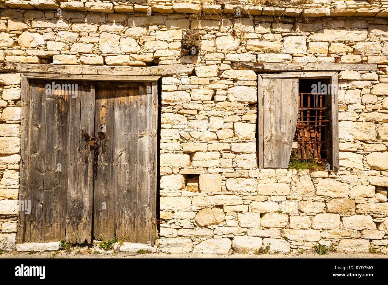 Old wooden door with chain and window in Limnatis village, Cyprus Stock ...
