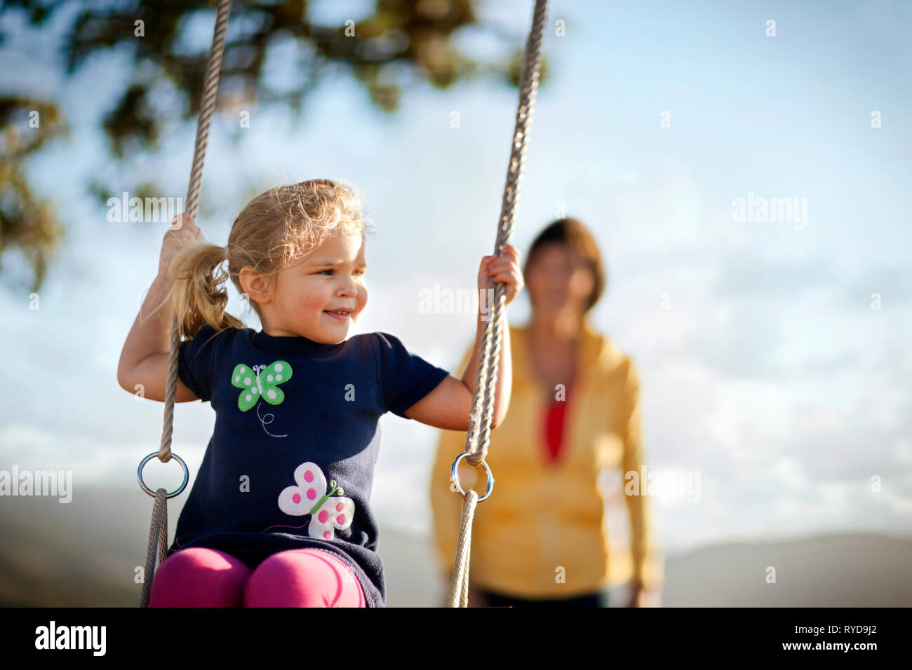 Young woman swings on rope hi-res stock photography and images - Alamy