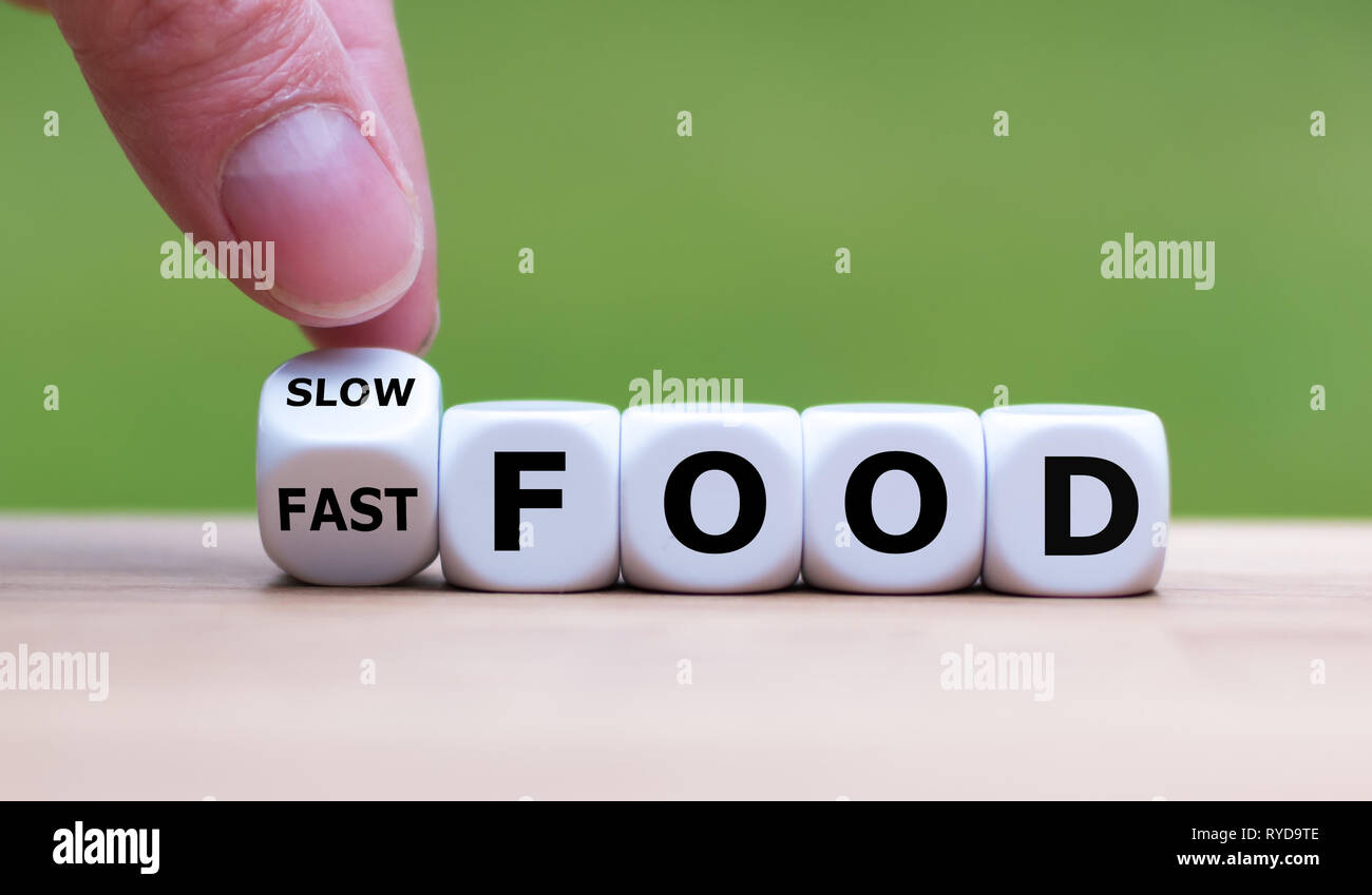 Hand turns a dice and changes the expression "fast food" to "slow food ...