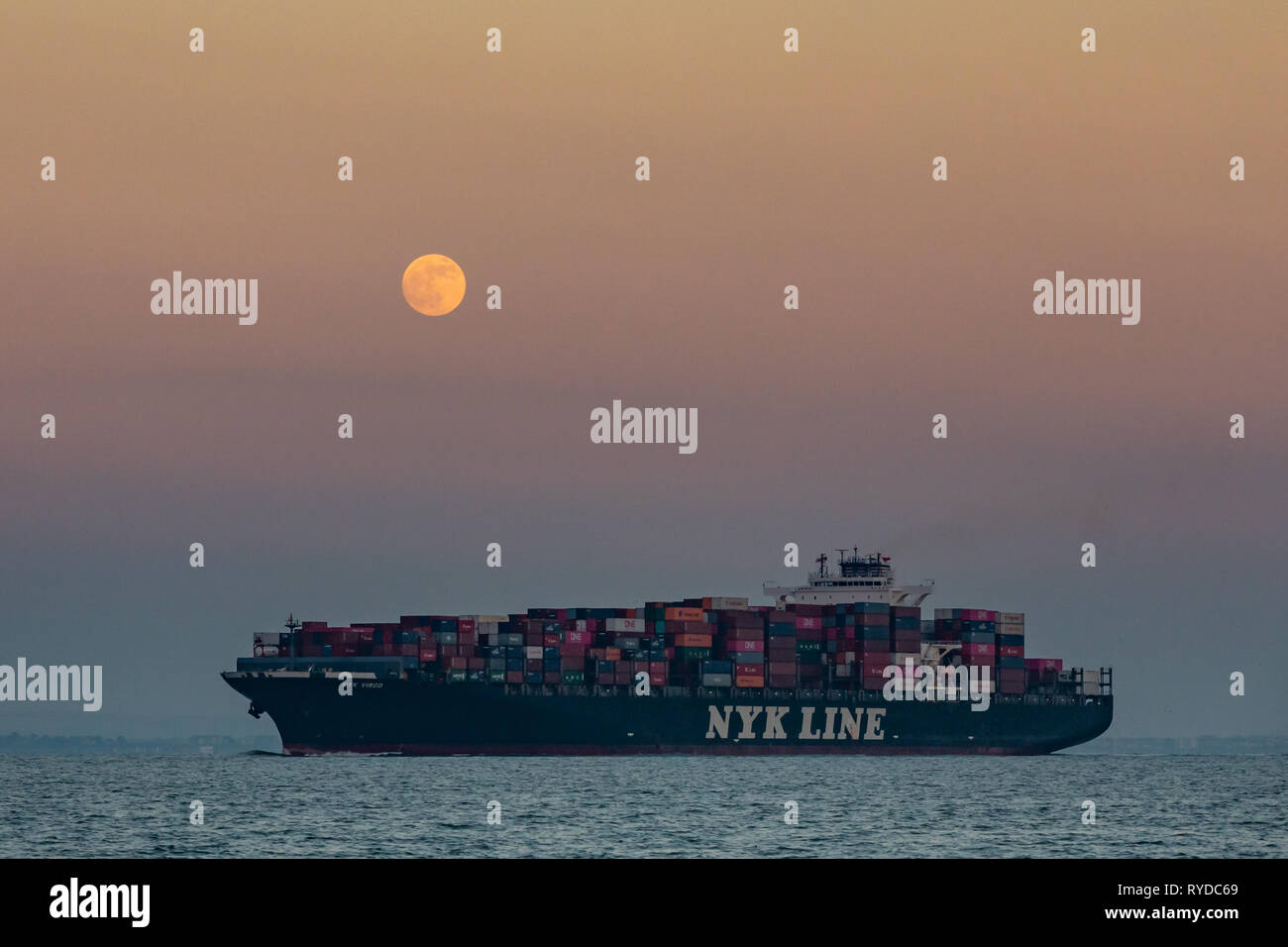 Cargo Ship under a Full Moon Stock Photo - Alamy