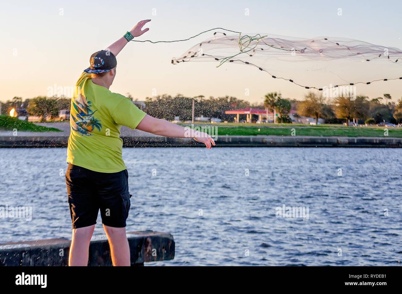 Man Throwing Fishing Net Into Water High Resolution Stock Photography ...
