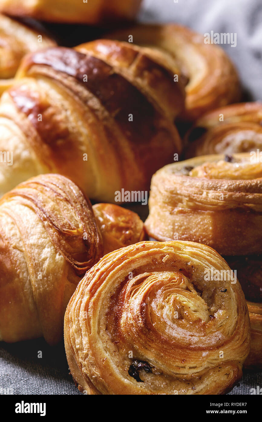 Variety of homemade puff pastry buns cinnamon rolls and croissant ...
