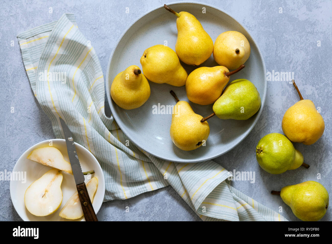 Whole pears with sliced pear in a dish Stock Photo - Alamy