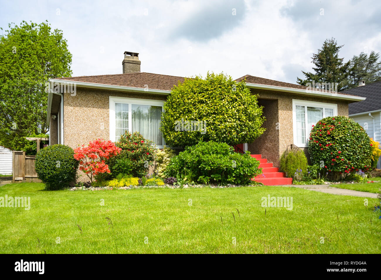 Average residential house with lush front yard lawn on cloudy day Stock ...