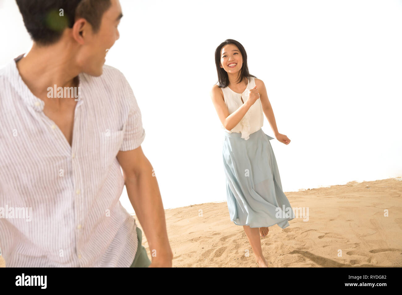Romantic young lovers play on the beach Stock Photo - Alamy