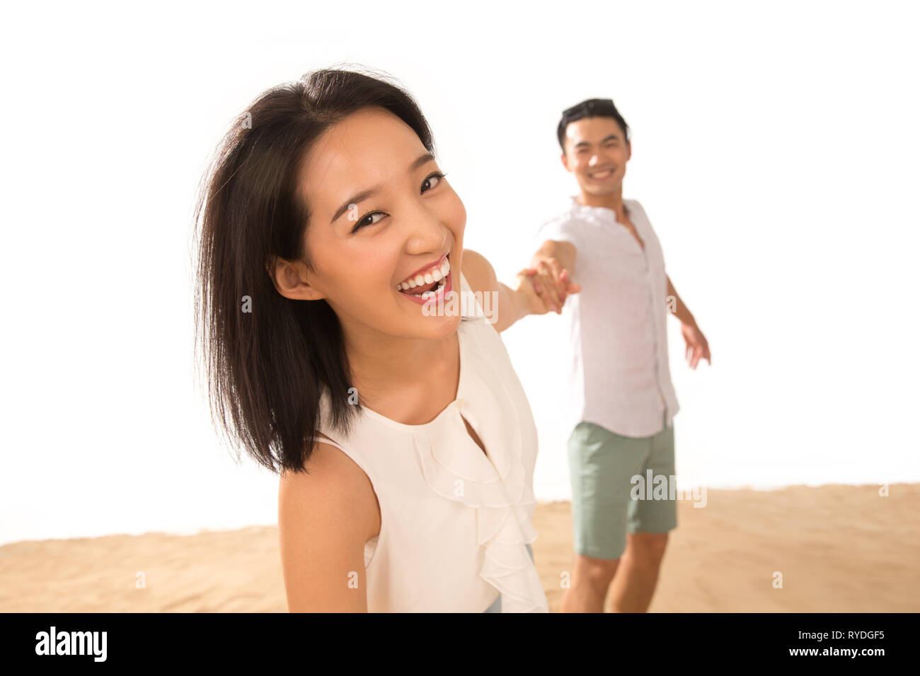 Romantic young lovers play on the beach Stock Photo - Alamy