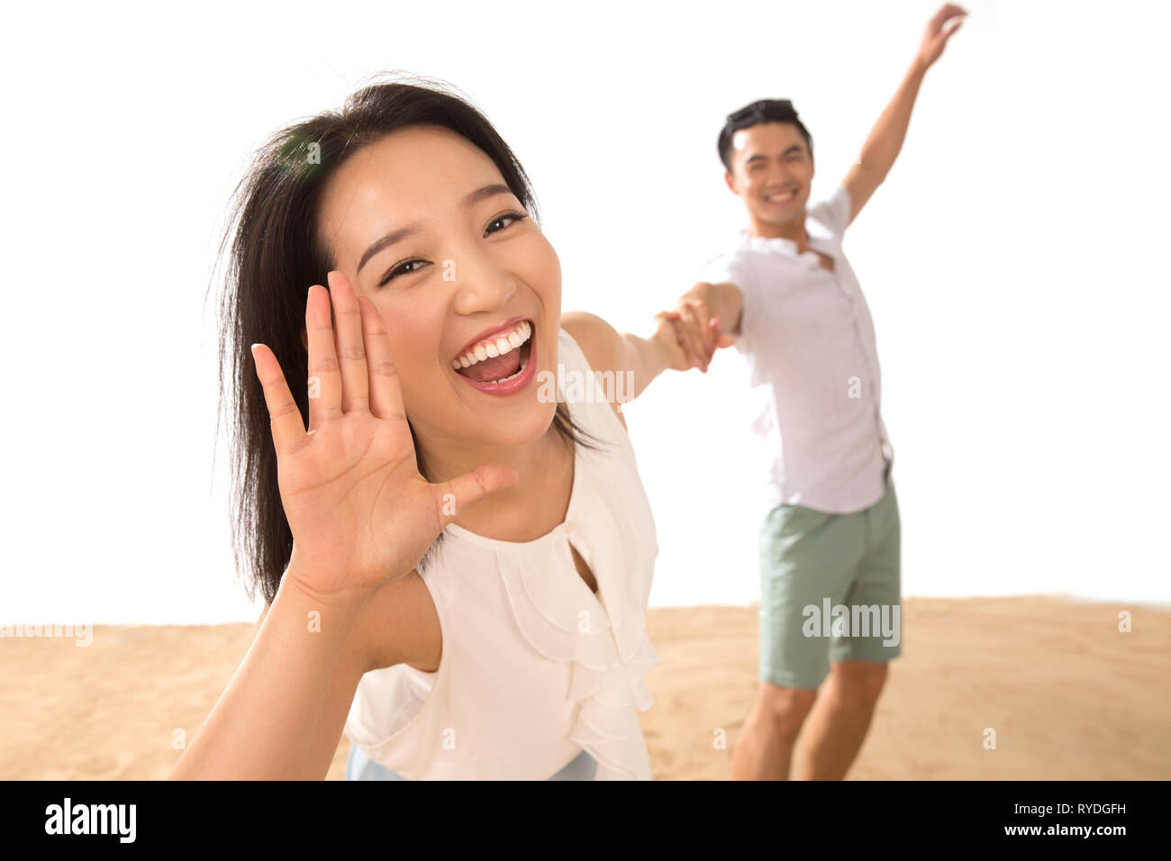 Romantic young lovers play on the beach Stock Photo - Alamy