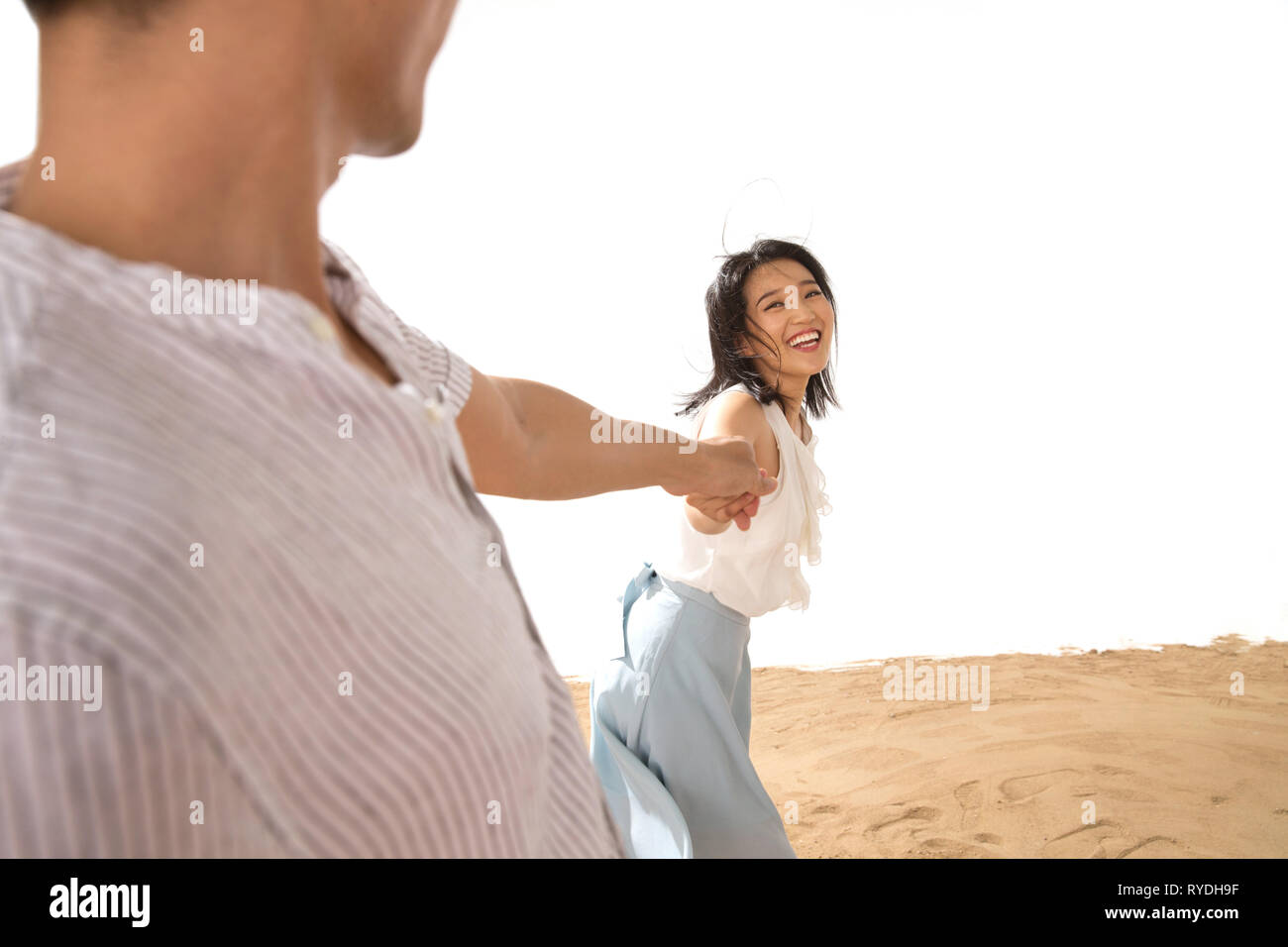 Romantic young lovers play on the beach Stock Photo - Alamy