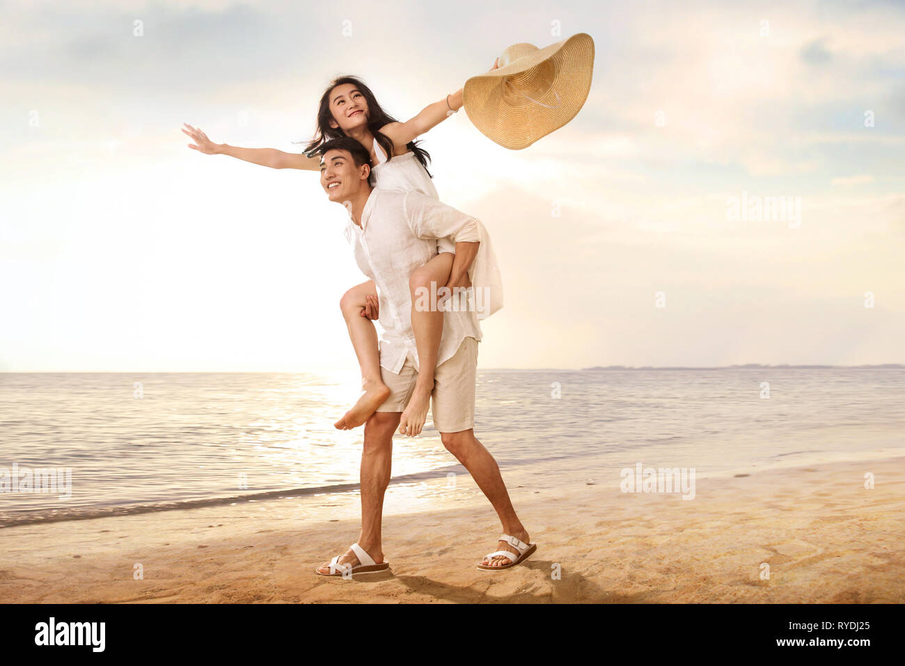 Young lovers play on the beach Stock Photo - Alamy