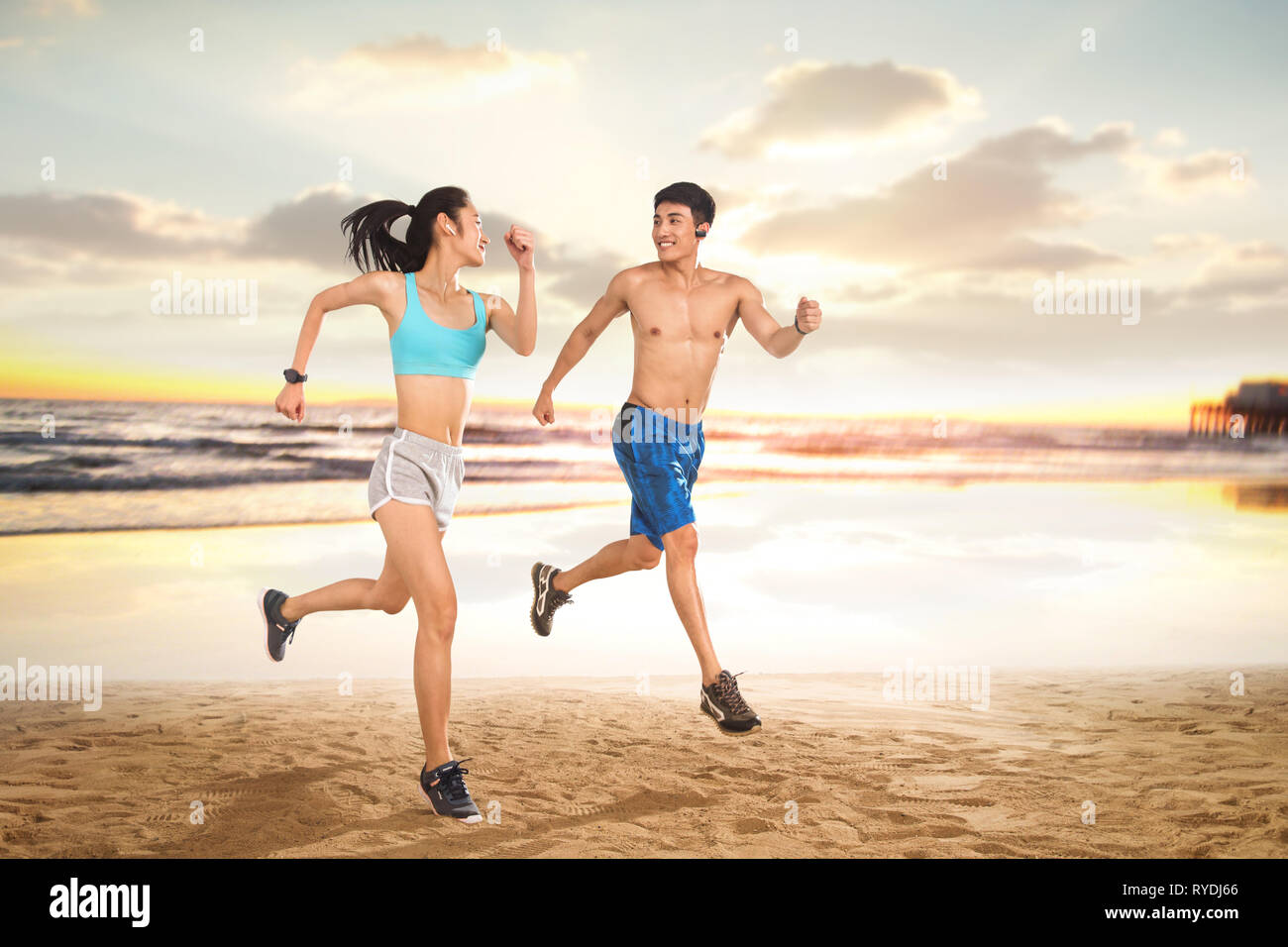Young couples running on the beach Stock Photo - Alamy
