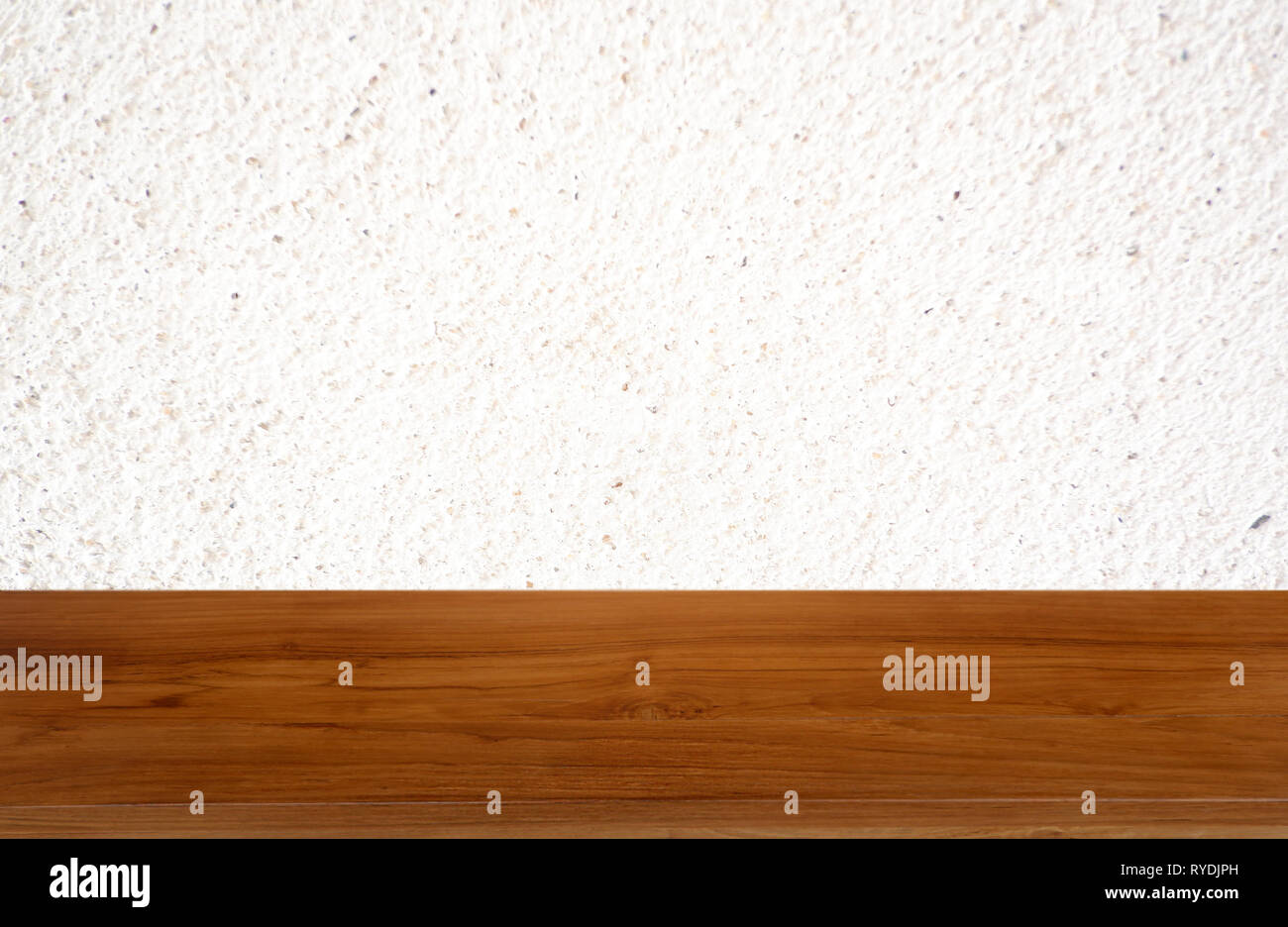 Tan wooden table on white background of cement wall textured- can be ...