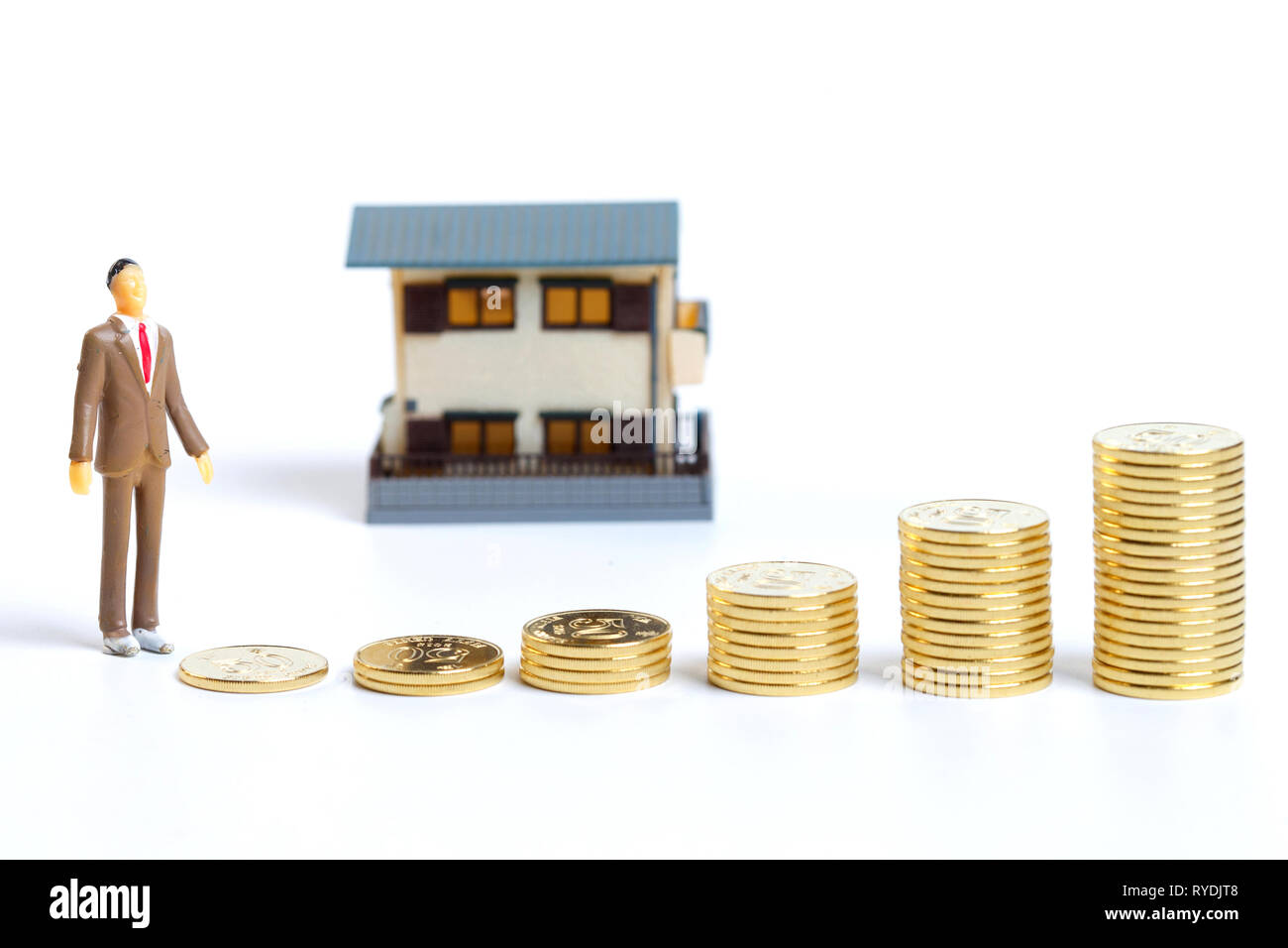 Gold COINS and building model Stock Photo - Alamy
