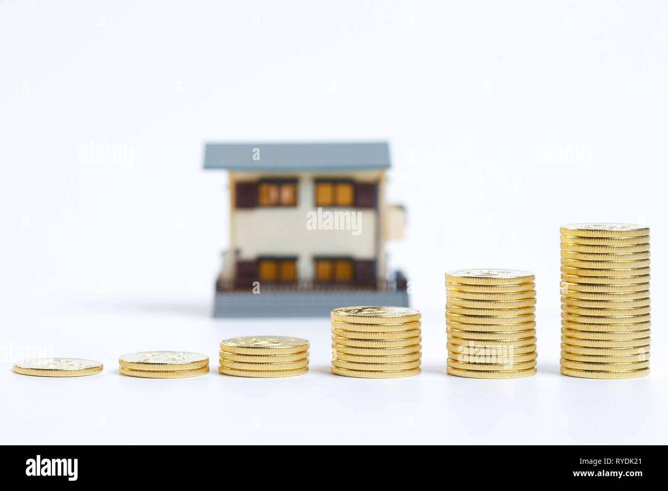 Gold COINS and building model Stock Photo - Alamy