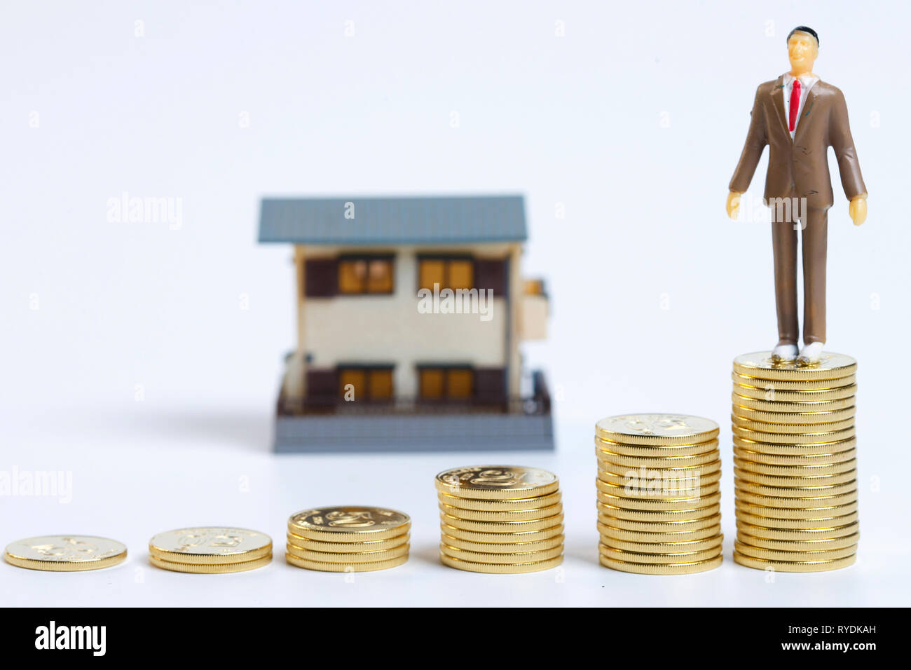 Gold COINS and building model Stock Photo - Alamy