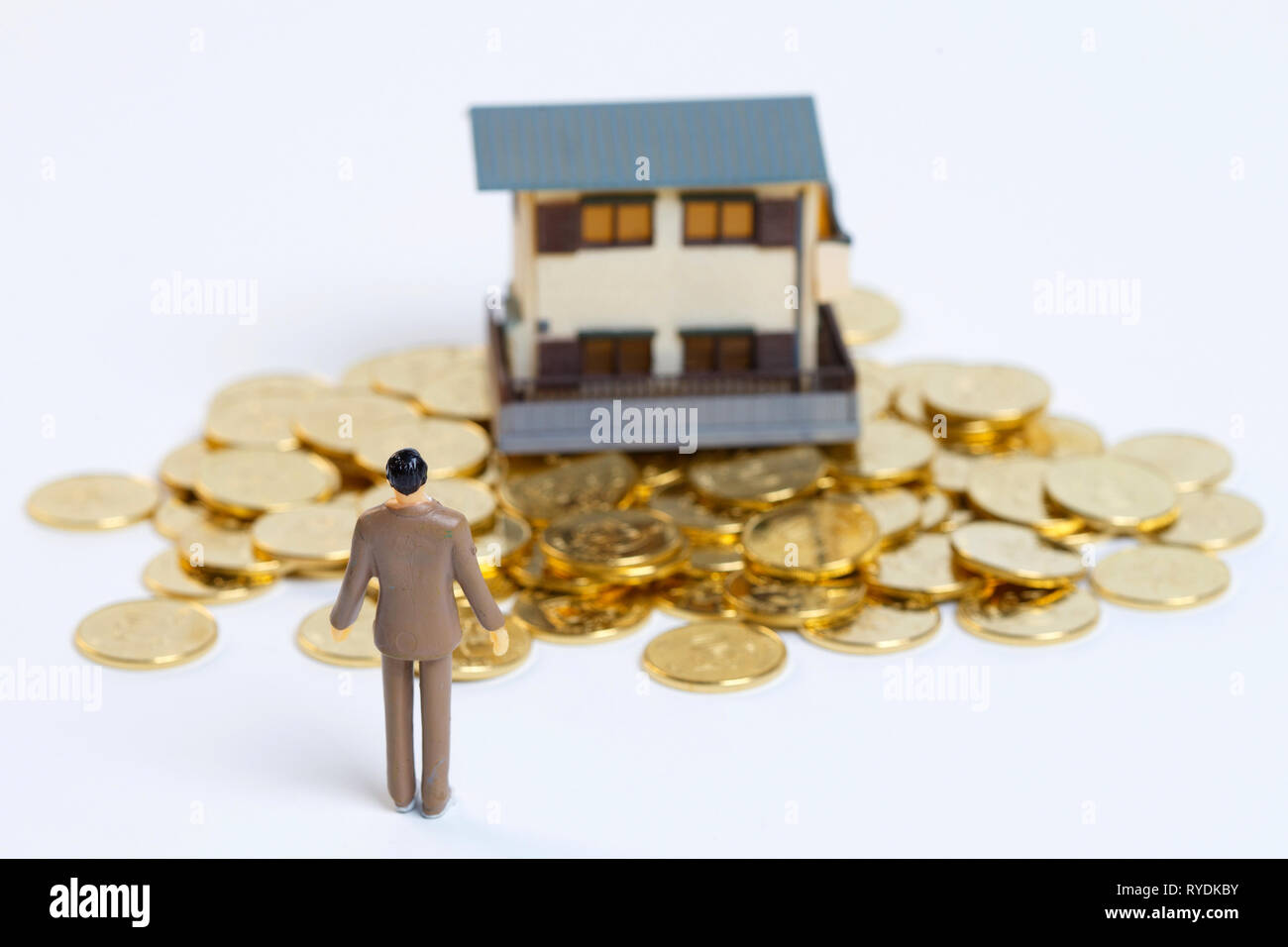 Gold COINS and building model Stock Photo - Alamy
