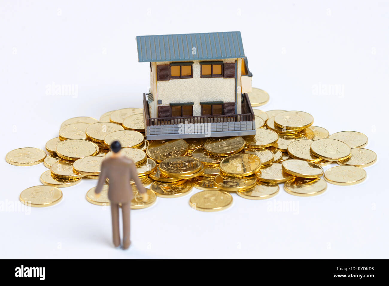Gold COINS and building model Stock Photo - Alamy