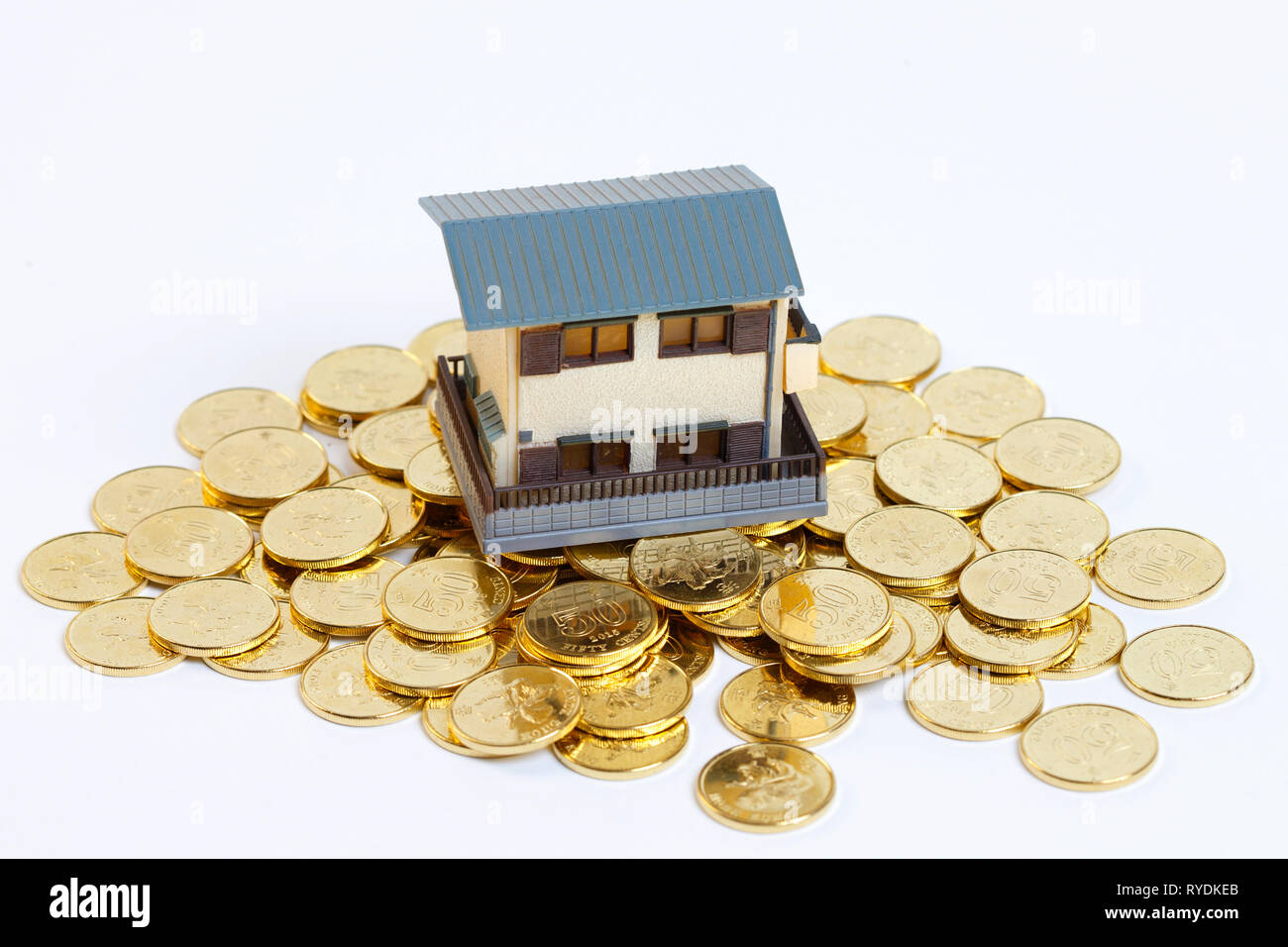 Gold COINS and building model Stock Photo - Alamy