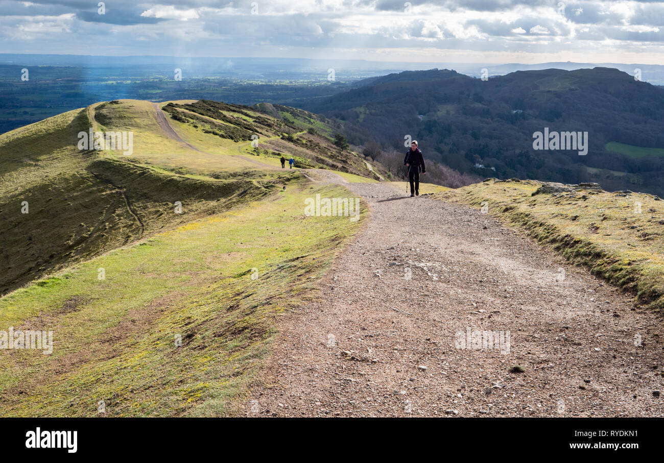 Female walker on the ridge walk over the Malvern Hills approaching ...