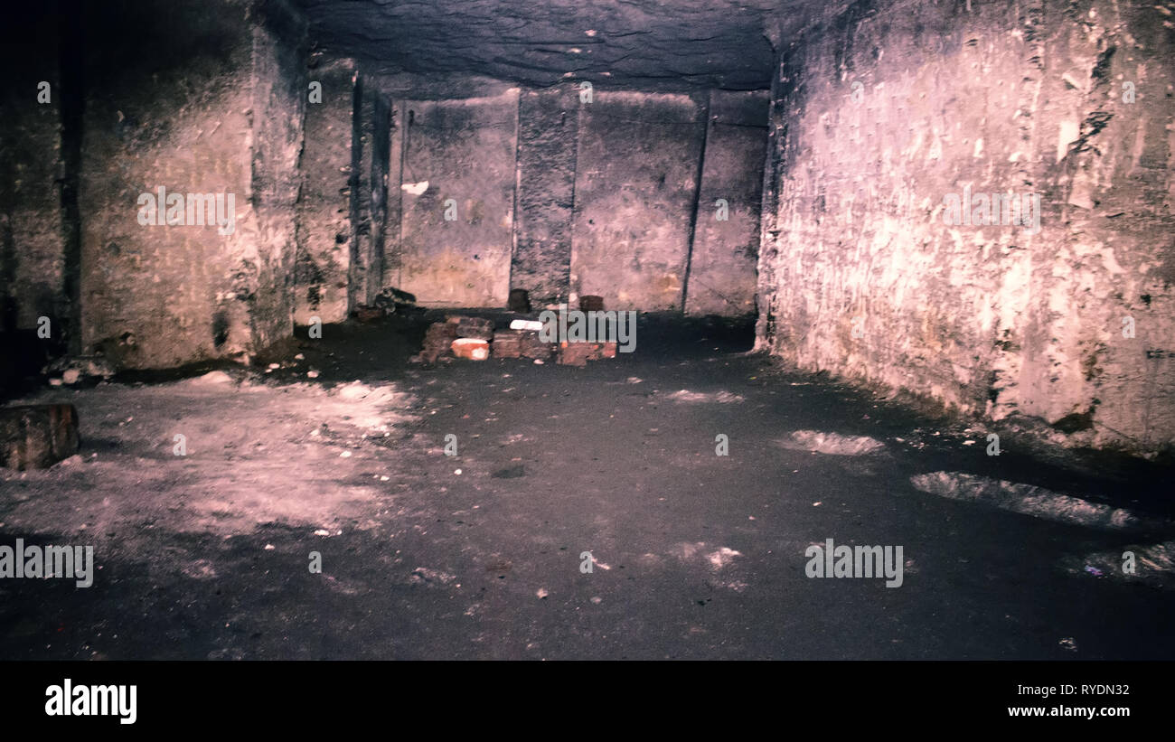 Old underground passage, catacombs lined with stones and slabs with ...