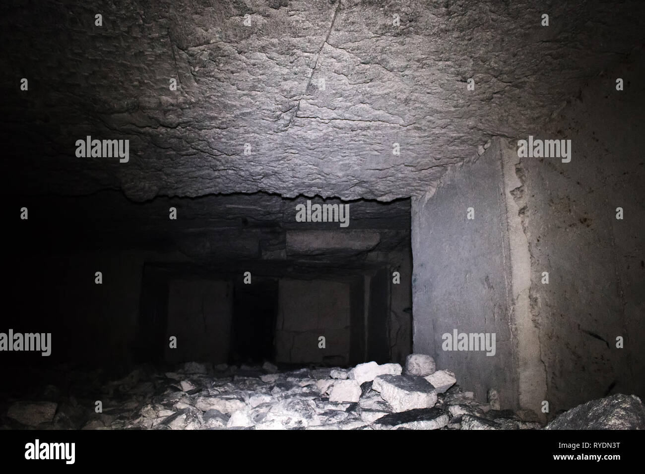 Old underground passage, dungeon, catacombs lined with stones and slabs ...